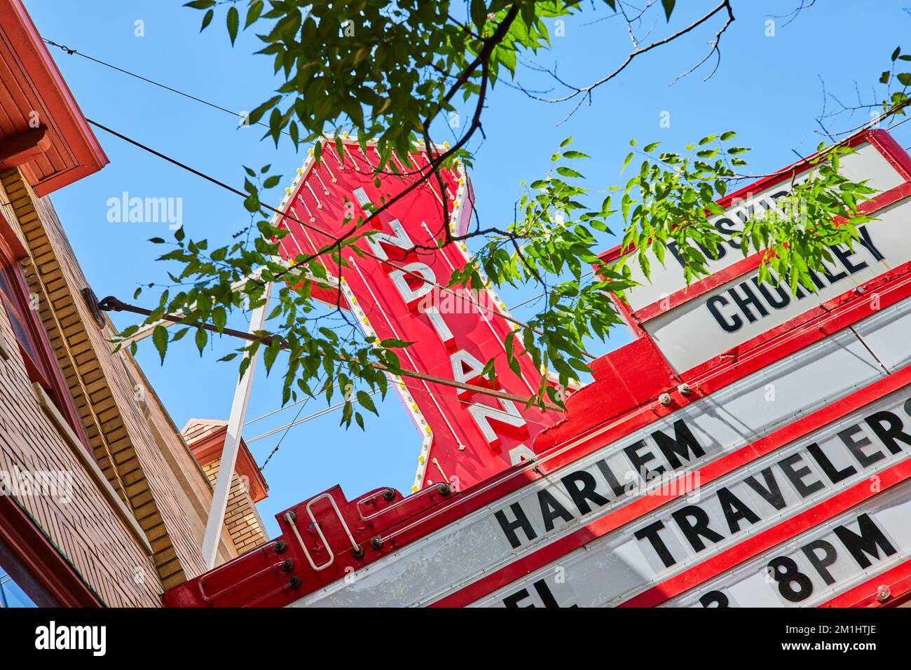Detail of red Indiana sign through trees for theater in Bloomington ...