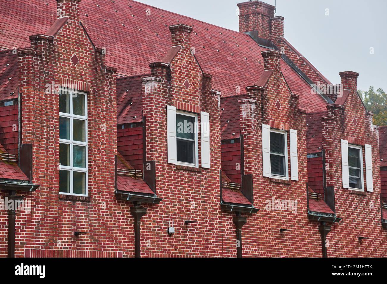 Detail top windows of old brick building with four overlooks Stock ...