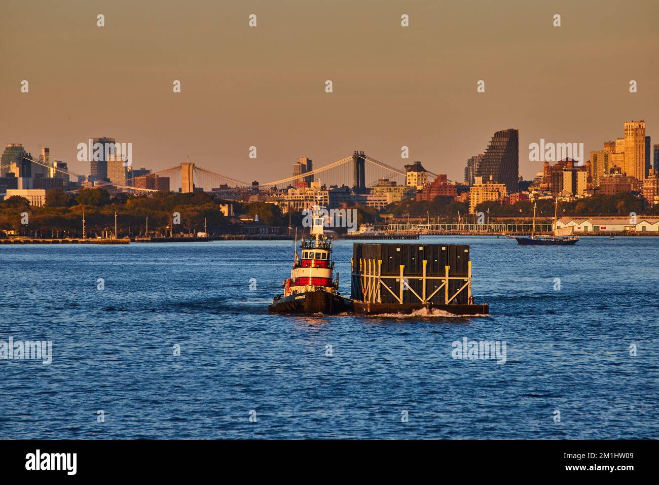Small industrial ship pulling shipping containers from side in ...