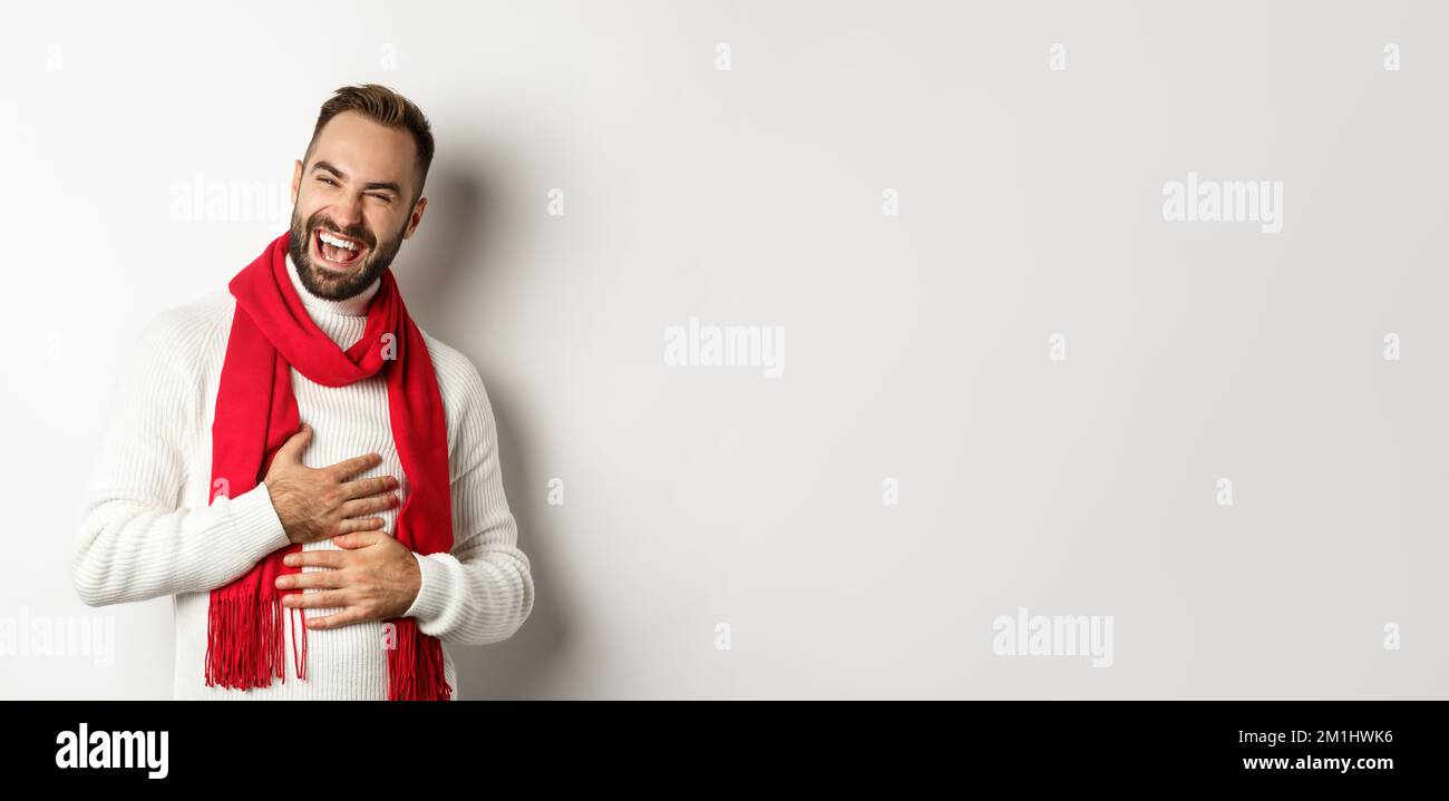 Happy man laughing and touching belly, chuckling from funny joke ...