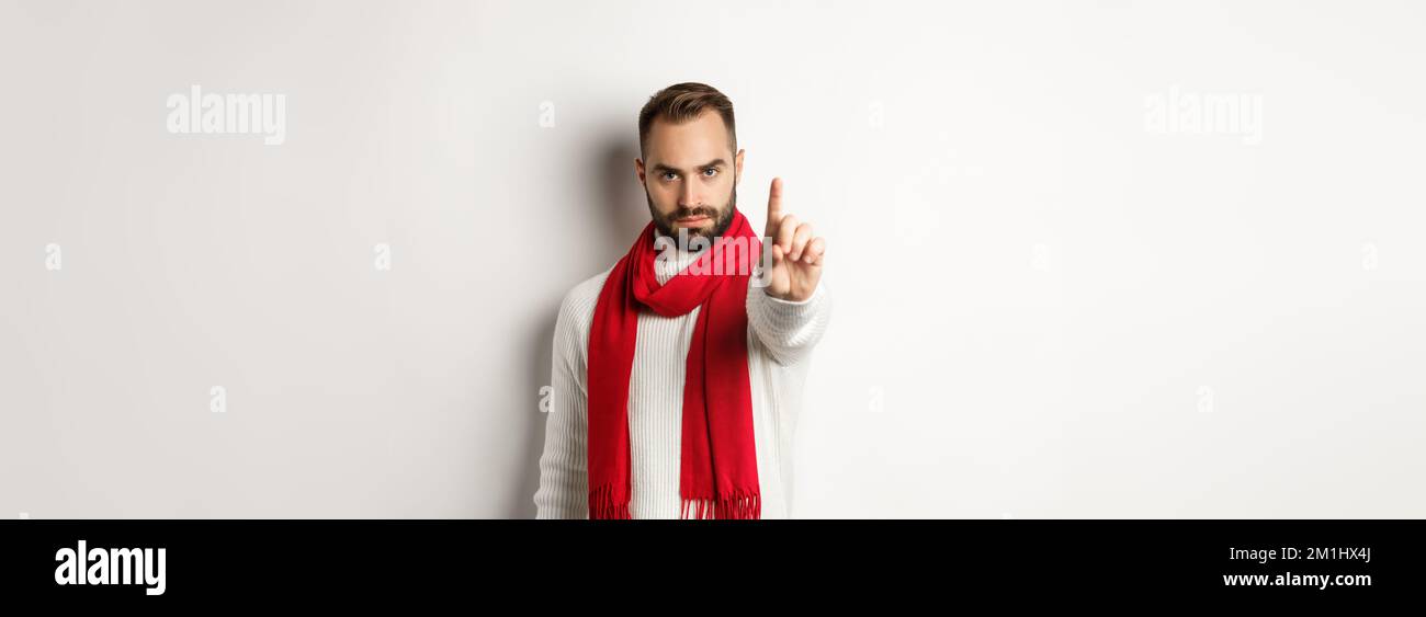 Serious man saying no, showing stop sign, shaking finger in decline ...