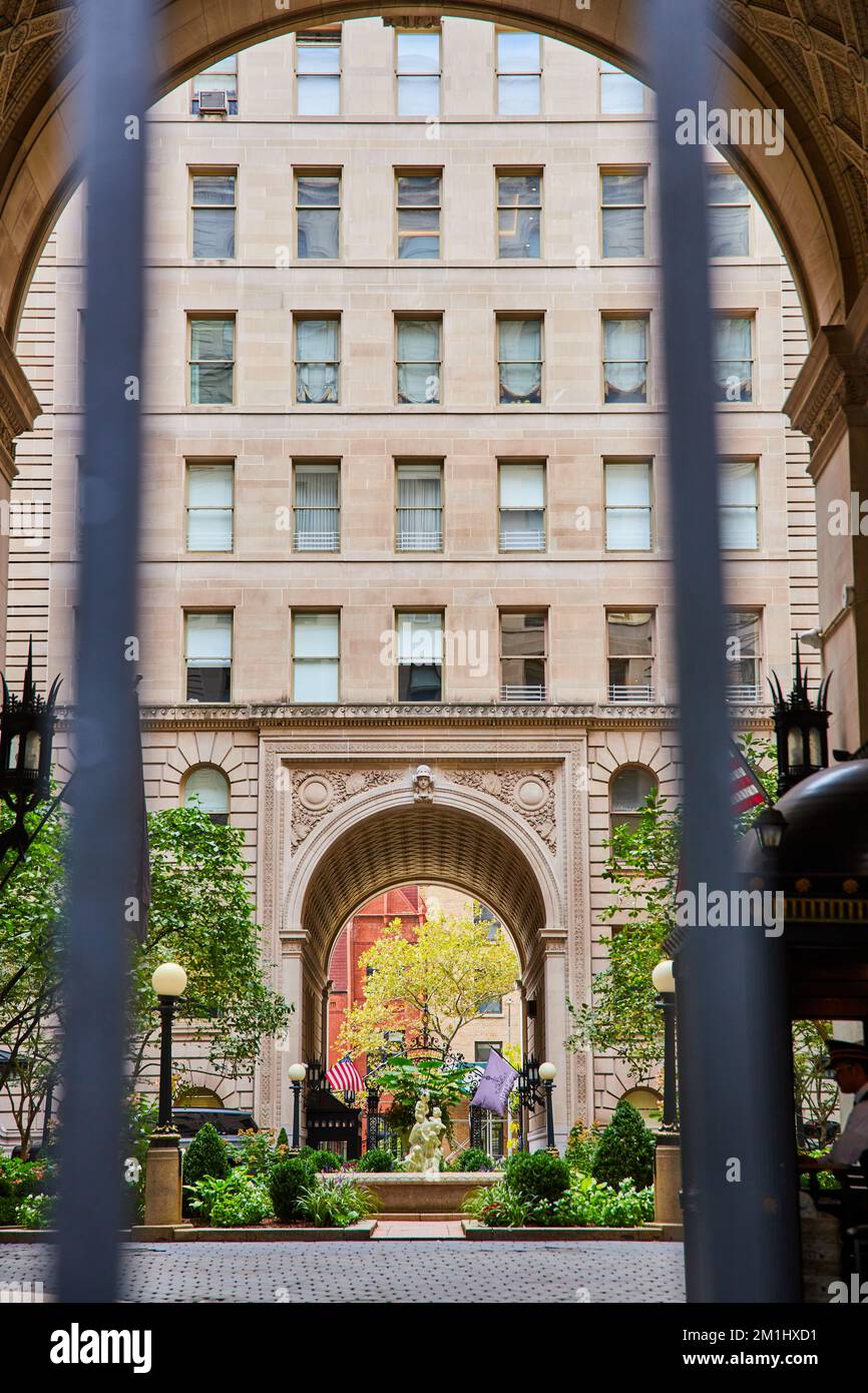 Looking through gate into beautiful New York City complex courtyard ...