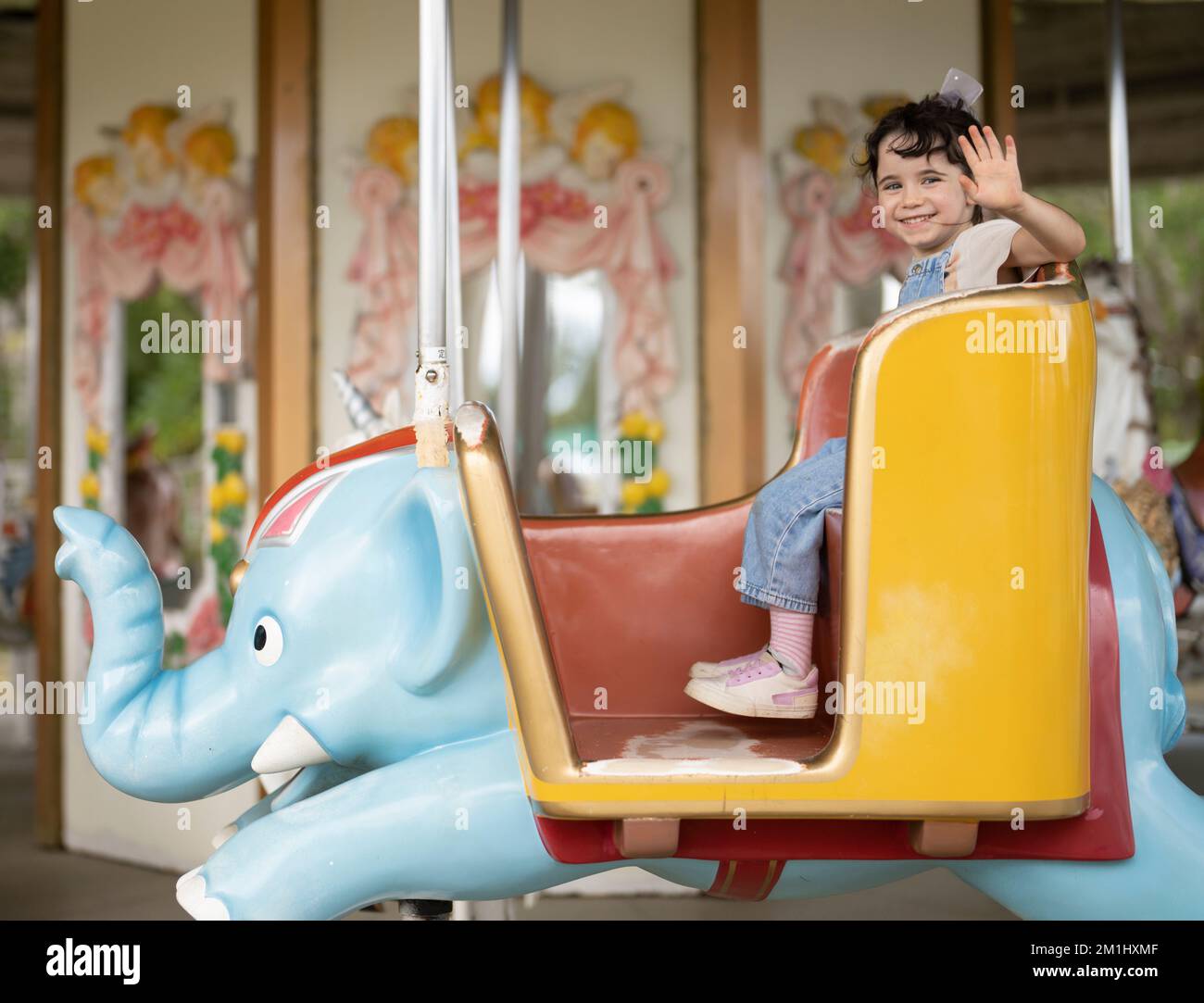 Child on merry-go-round carousel at Okinawa Zoo & Museum Stock Photo ...