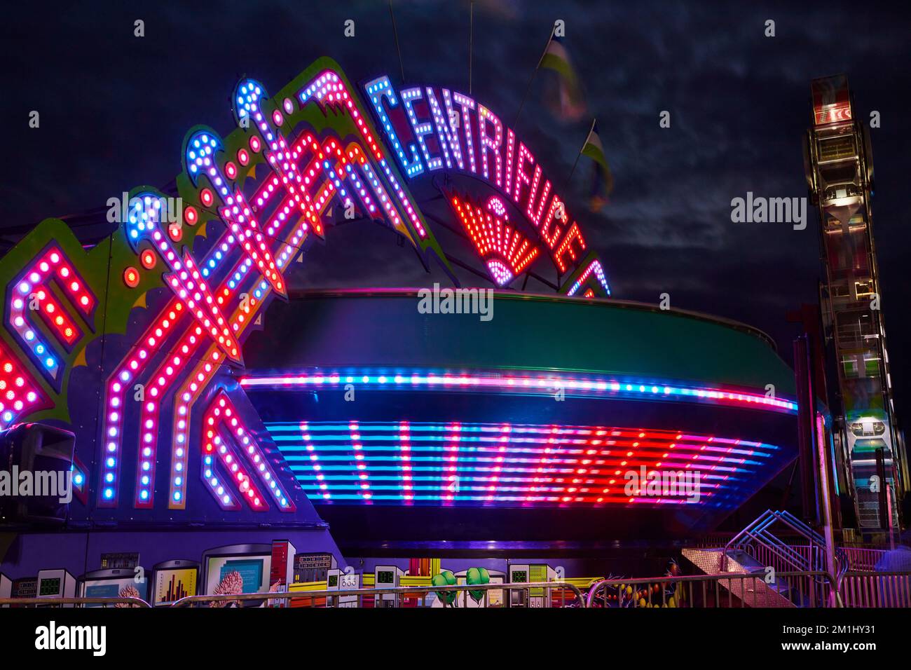 County Fair carnival ride lights of red and blue from outside Stock ...