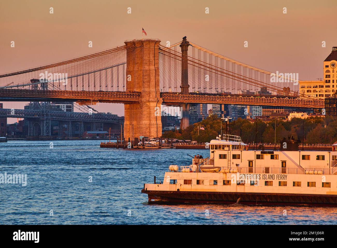 Governors Island Ferry in golden hour sunset dusk light from waters ...