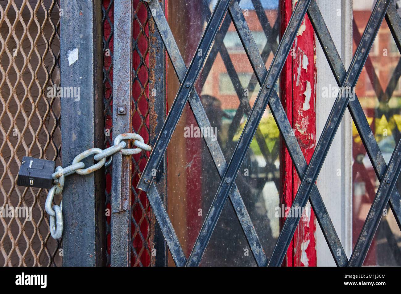 Black fence blocking door in detail with chains Stock Photo - Alamy