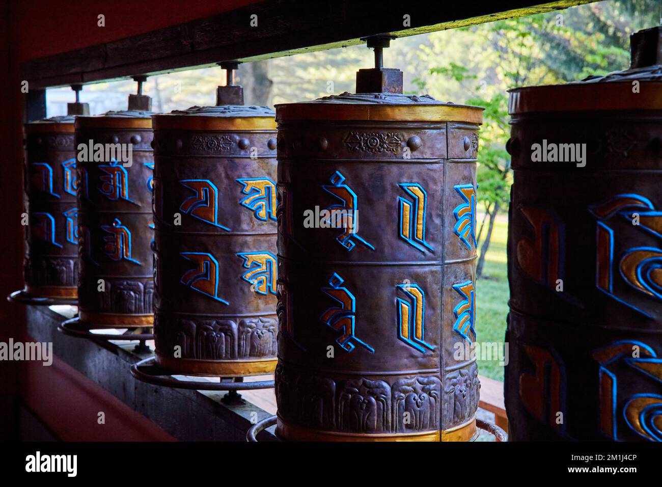 Shadows of large prayer wheels at Tibetan Mongolian Buddhist shrine ...