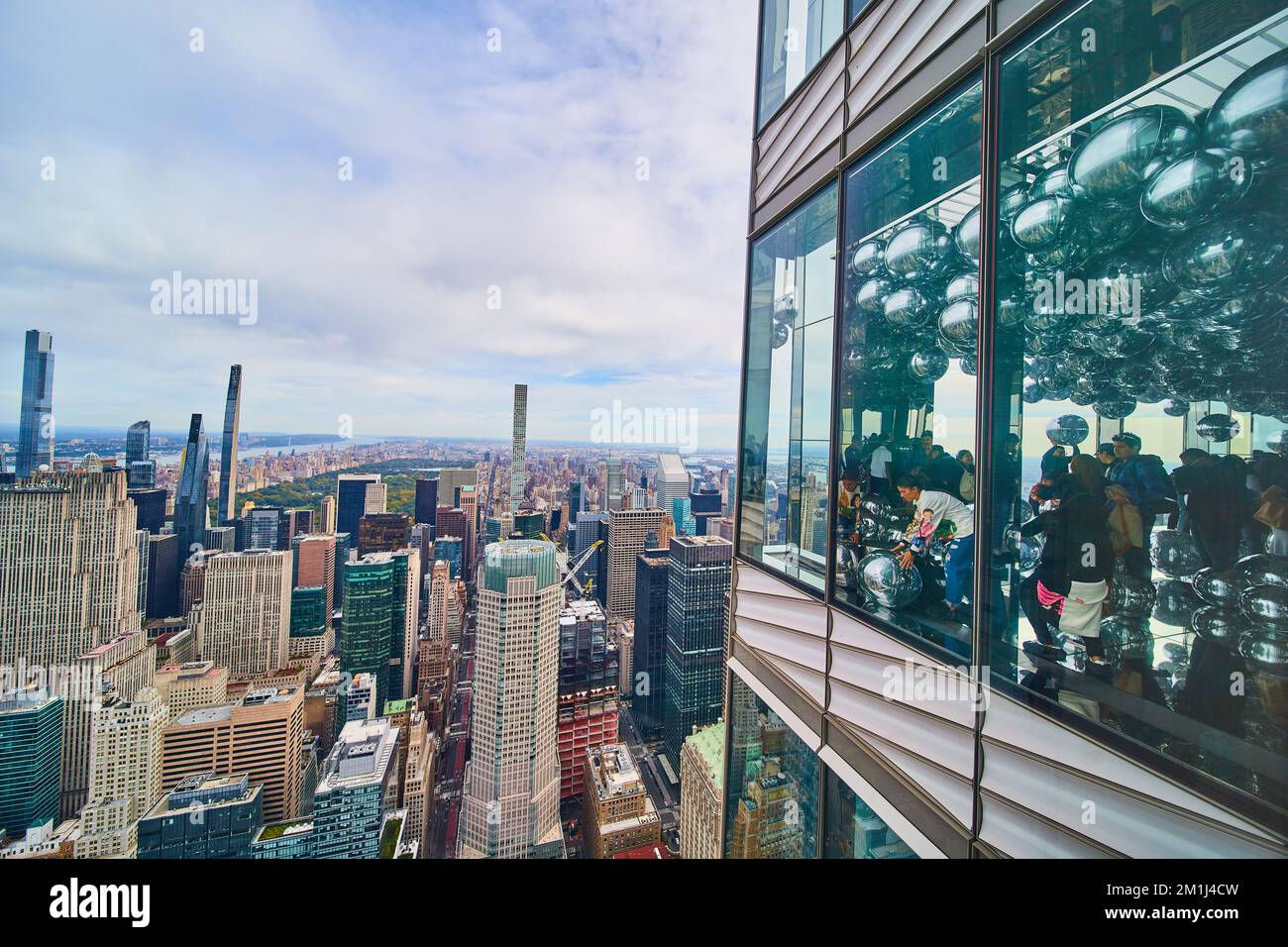 High up skyscraper outside wall and inside of metal balls with view of ...