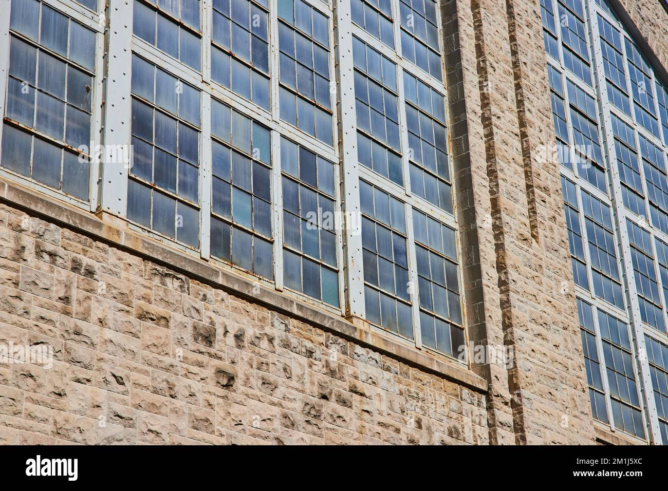Industrial building exterior with faded window panels of different ...
