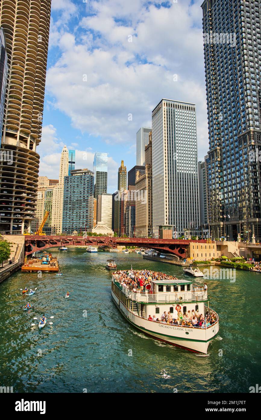 Chicago ship canal lined with skyscrapers and large tourist ship ...