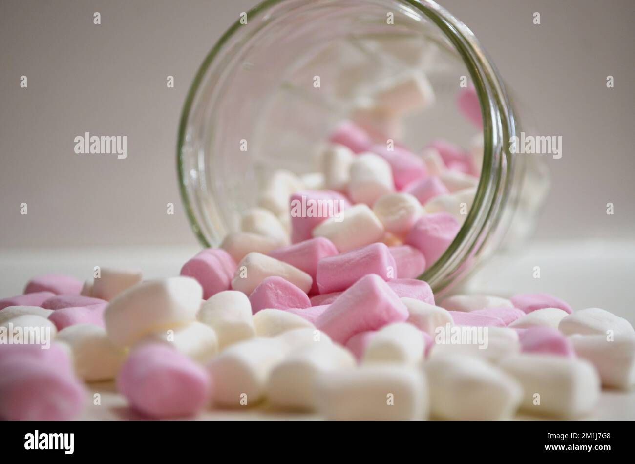 Mini, small Marshmallows poured from jar on to kitchen bench Stock ...