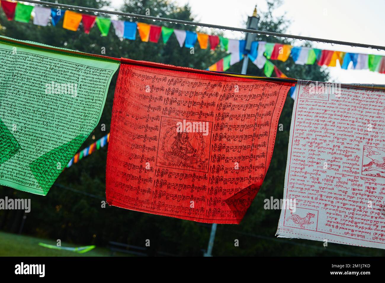 Rope with green, red, and white Tibetan Mongolian Buddhist prayer flags ...