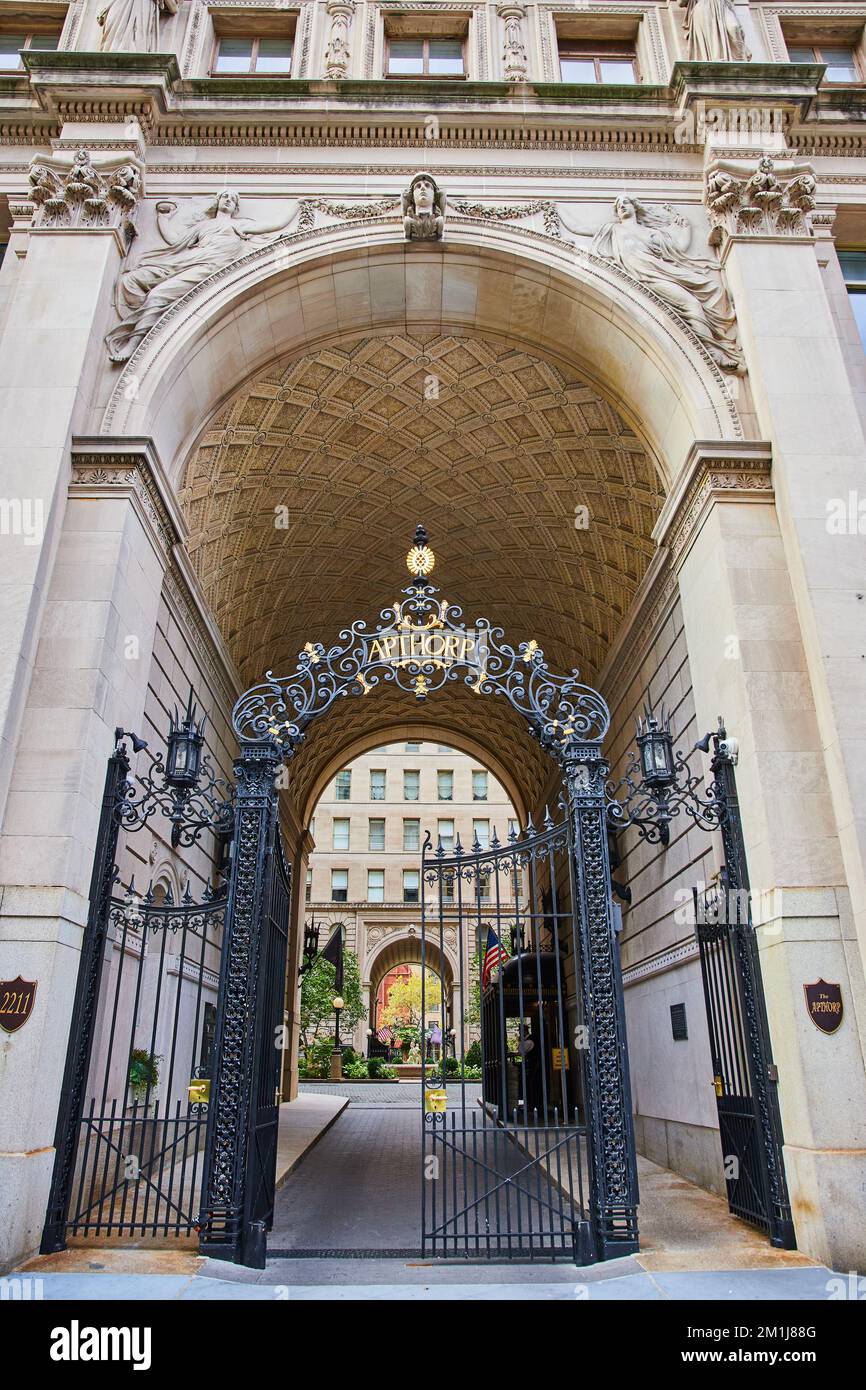 Limestone arch blocked by black steel gates lead into beautiful hidden ...
