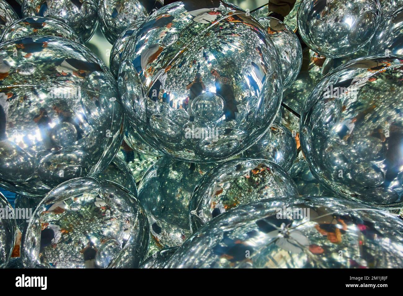 Endless sphere balloons reflecting tourists and spheres Stock Photo - Alamy