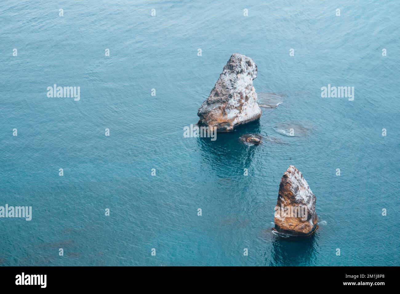 Two huge stones in the middle of the sea Stock Photo - Alamy