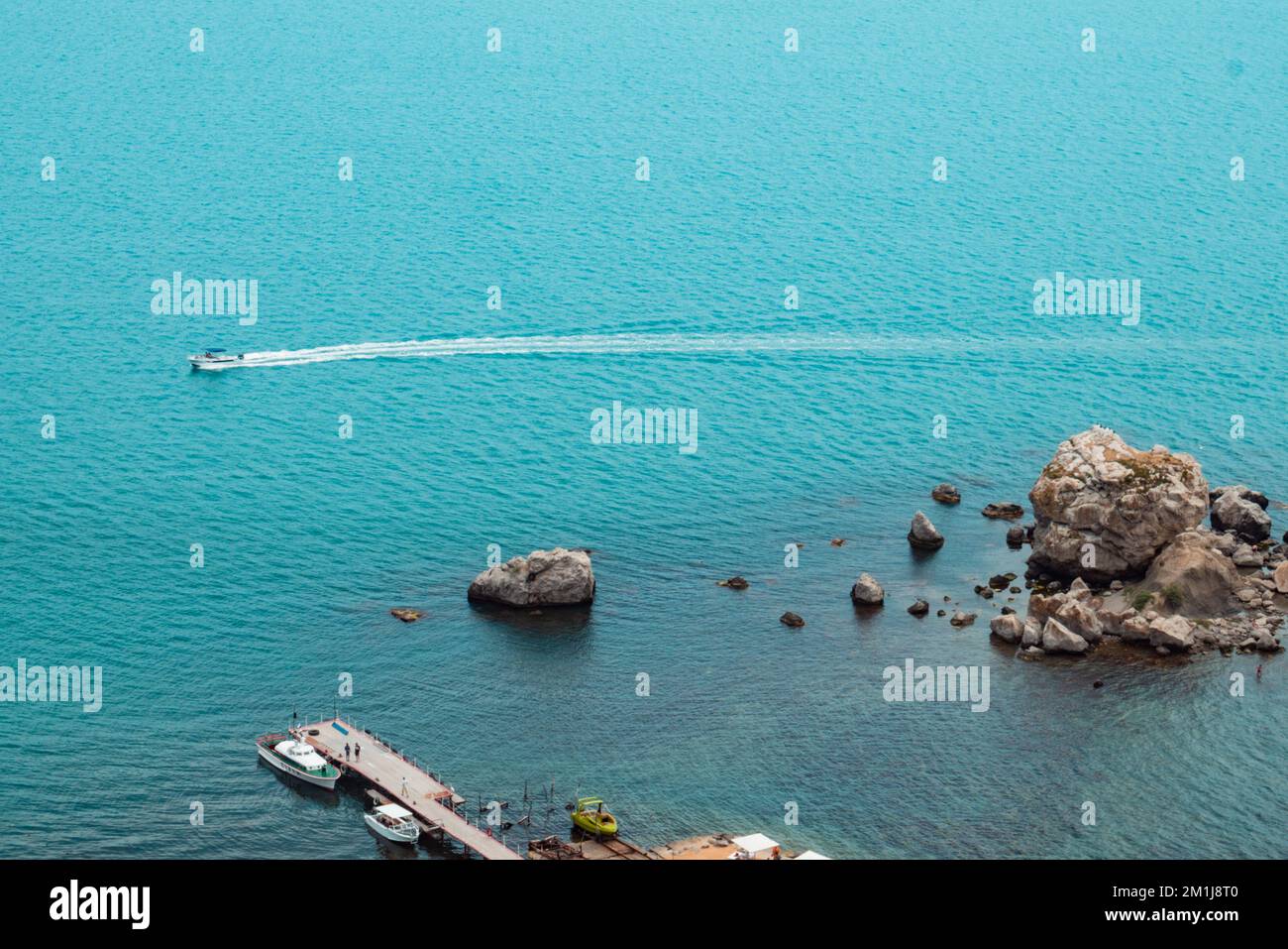 White yacht in a beautiful azure bay Stock Photo - Alamy