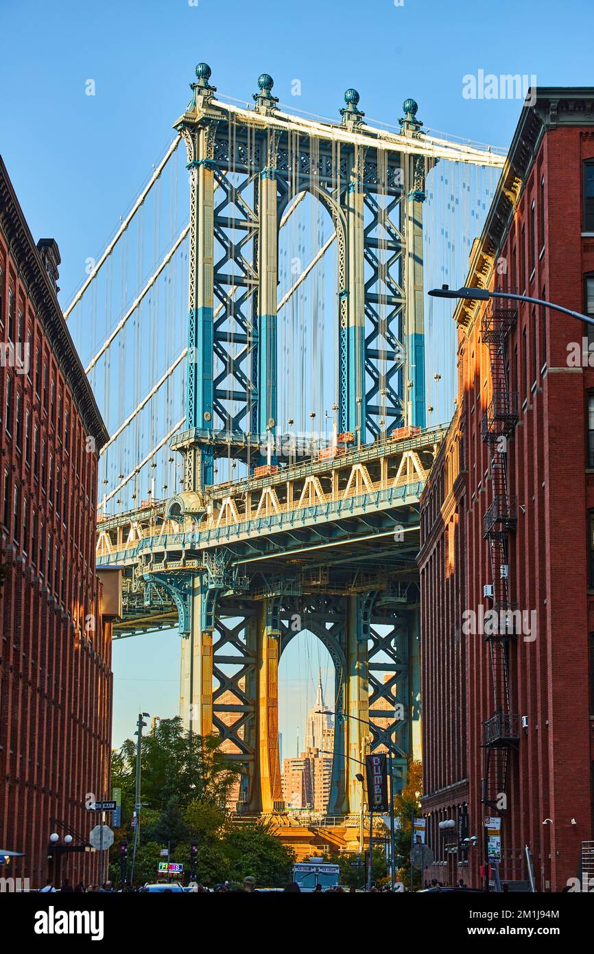 Sunny Manhattan Bridge from Brooklyn New York City between two brick ...