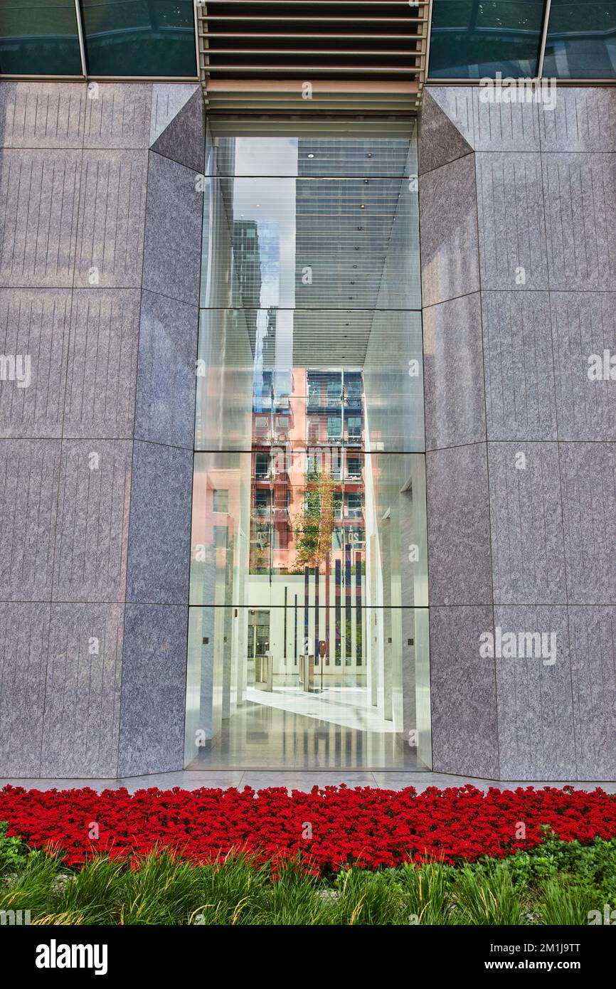 View outside large building with glass view into fancy lobby and red ...