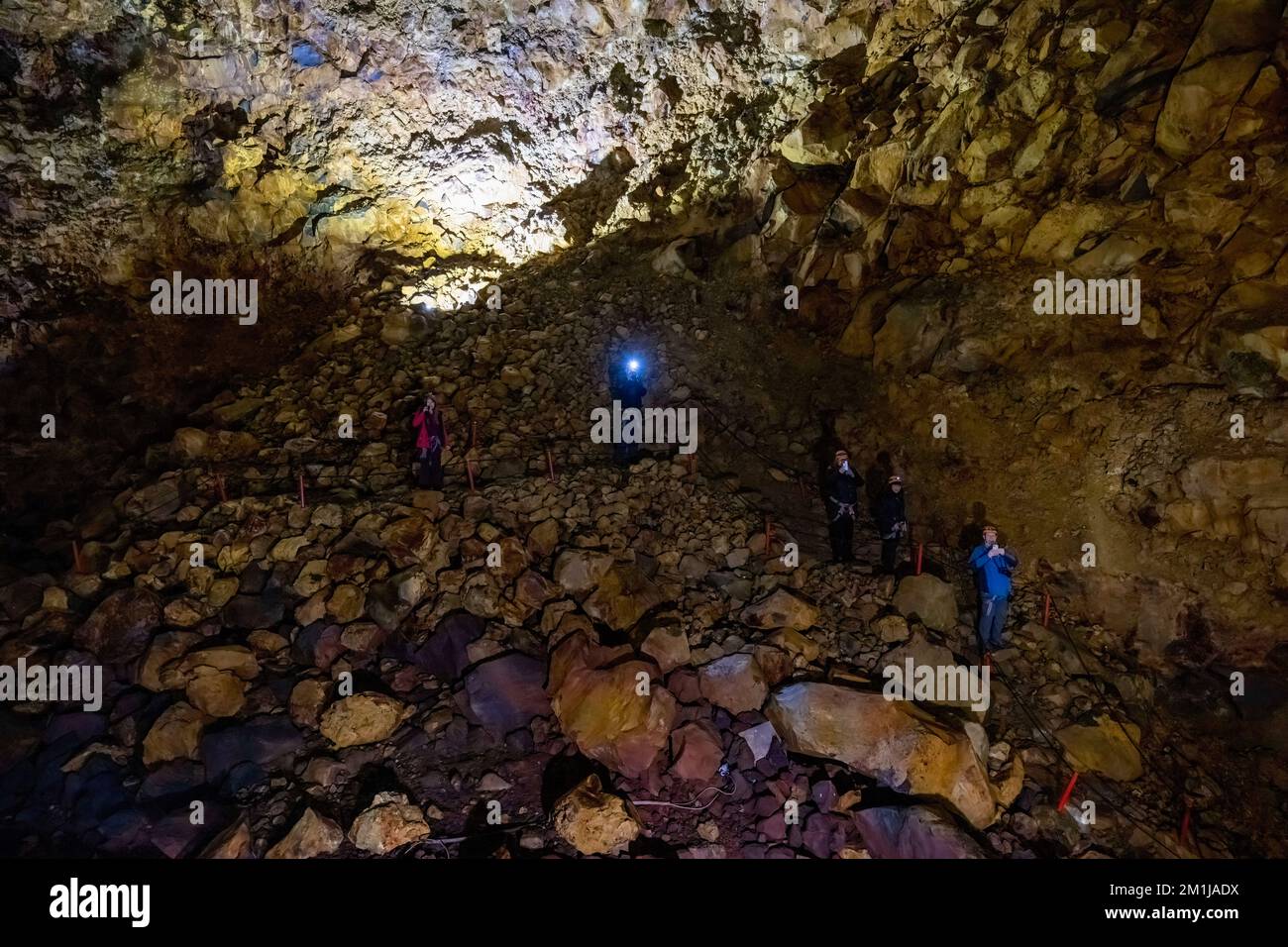 People are seen walking through the crater of the Thríhnúkagígur ...
