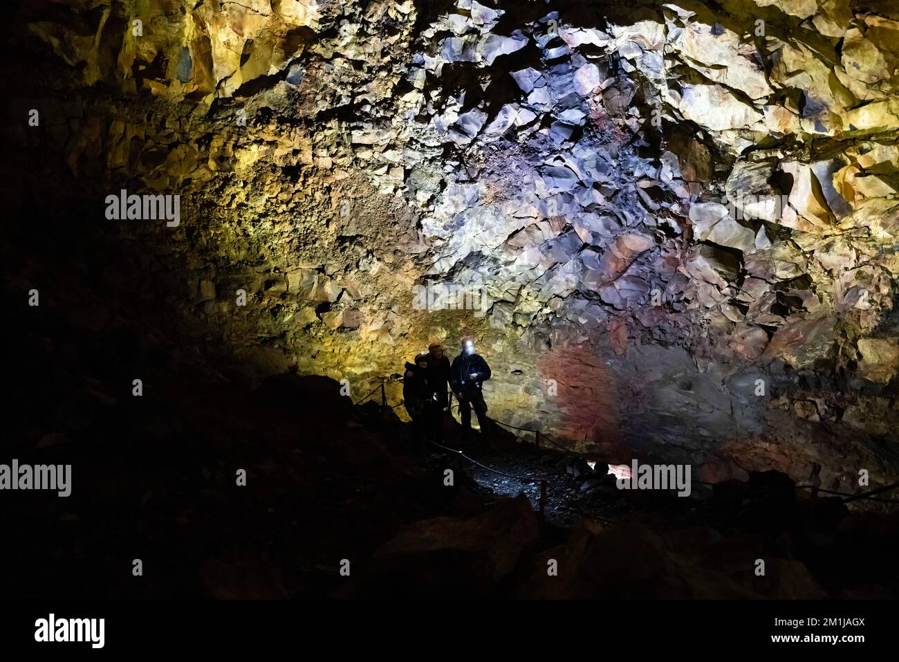 People are seen walking through the crater of the Thríhnúkagígur ...