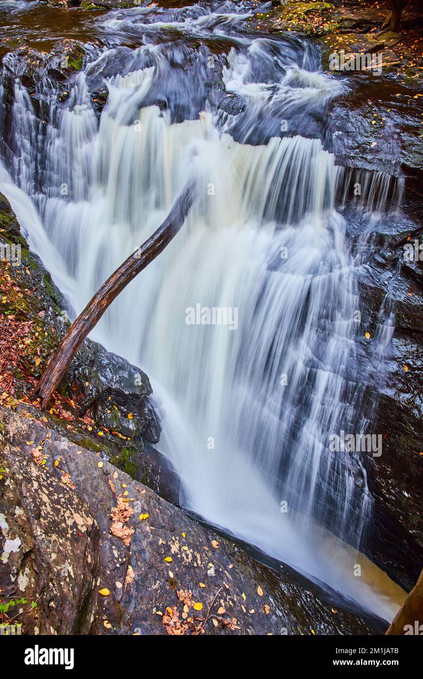 River rages down steep gorge into rocks with fall leaves Stock Photo ...