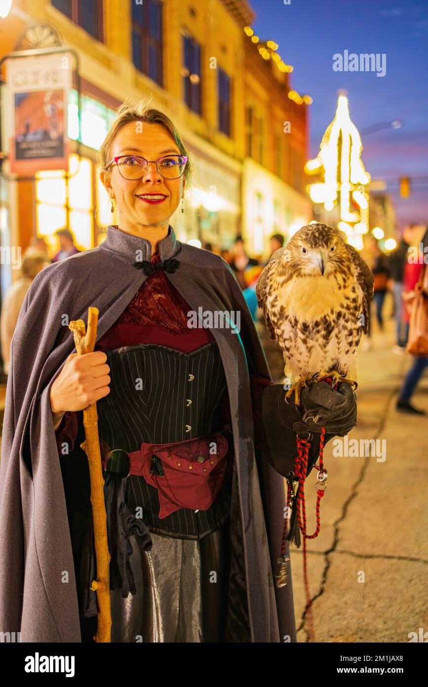 Oklahoma, DEC 10 2022 - People with falcon in Guthrie Victorian walk ...