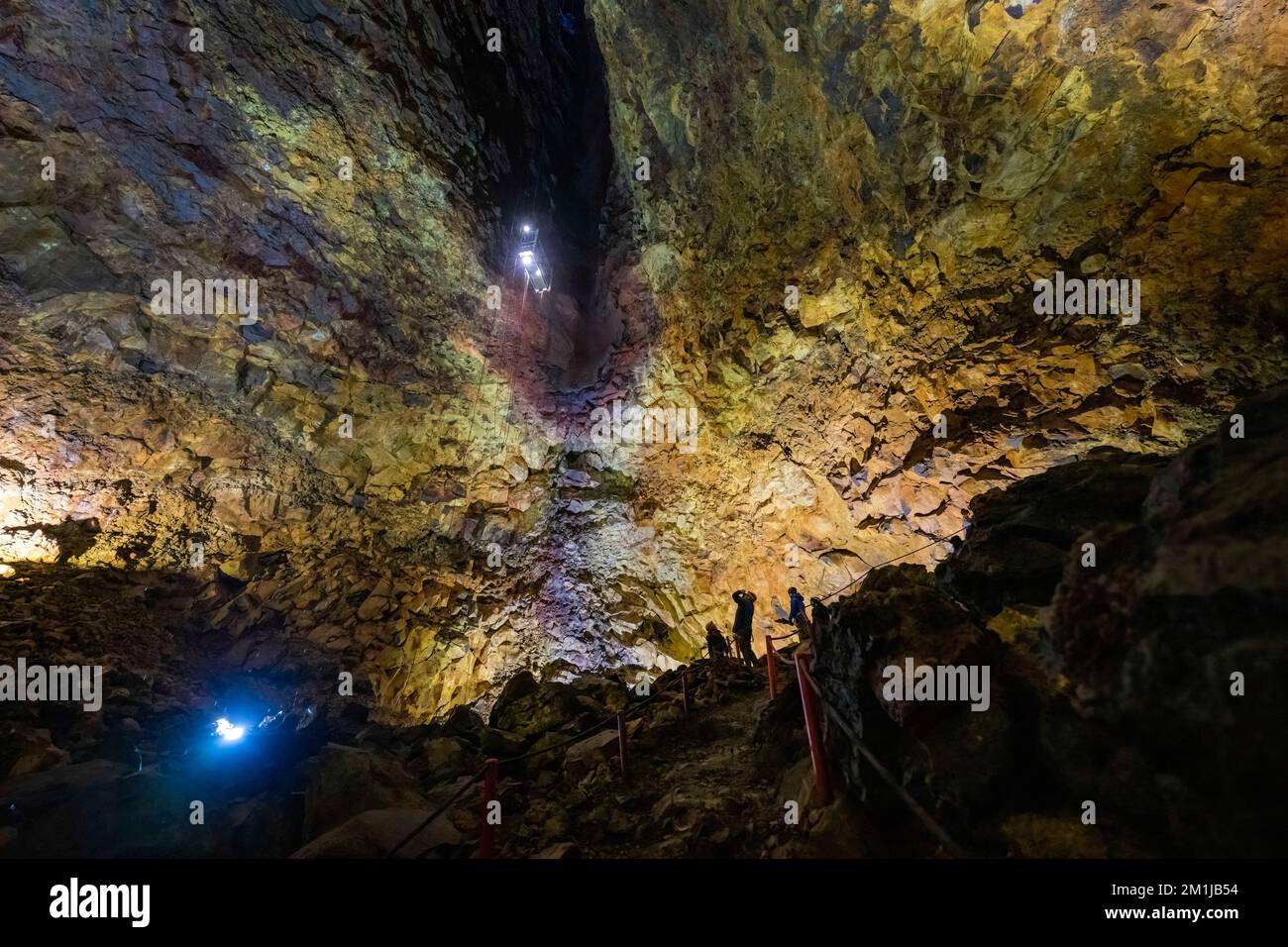 People are seen walking through the crater of the Thríhnúkagígur ...