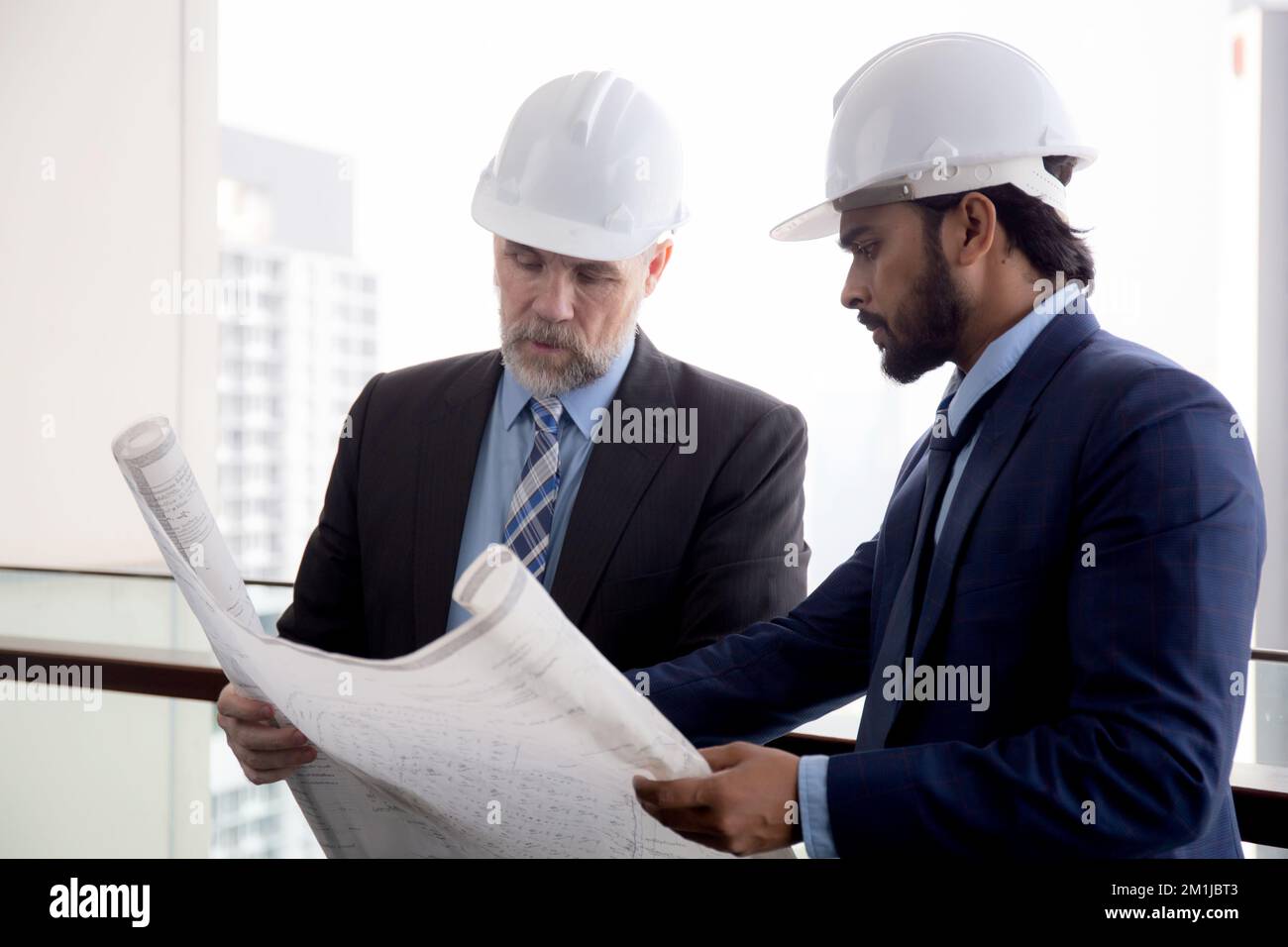 Senior architect inspector check blueprint and structure with ...
