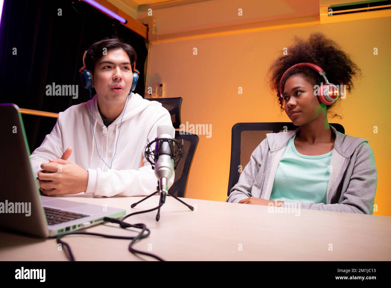 Young African American woman and asian man a podcast interview and ...