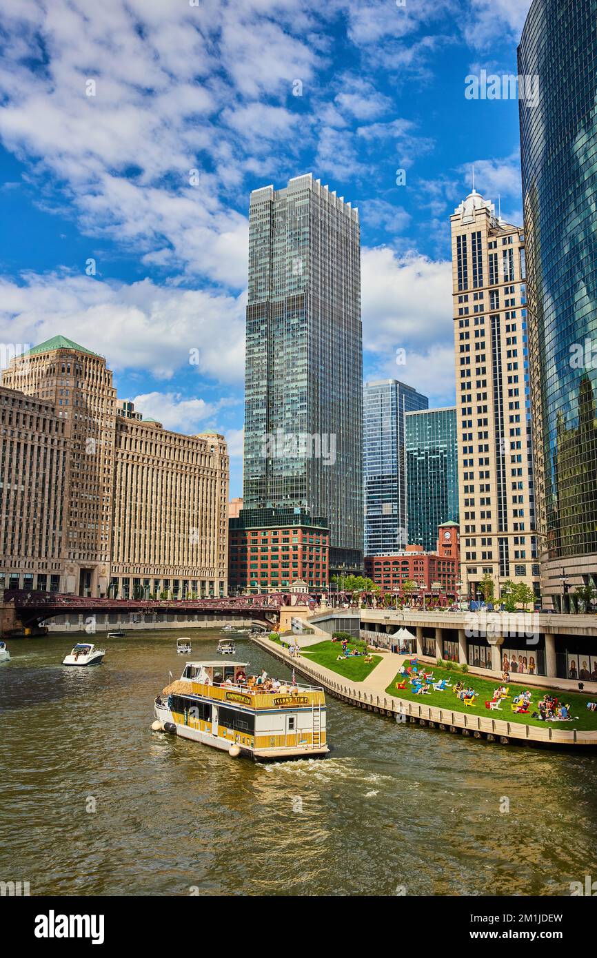 Tropical ship sailing through river canals of Chicago surrounded by ...