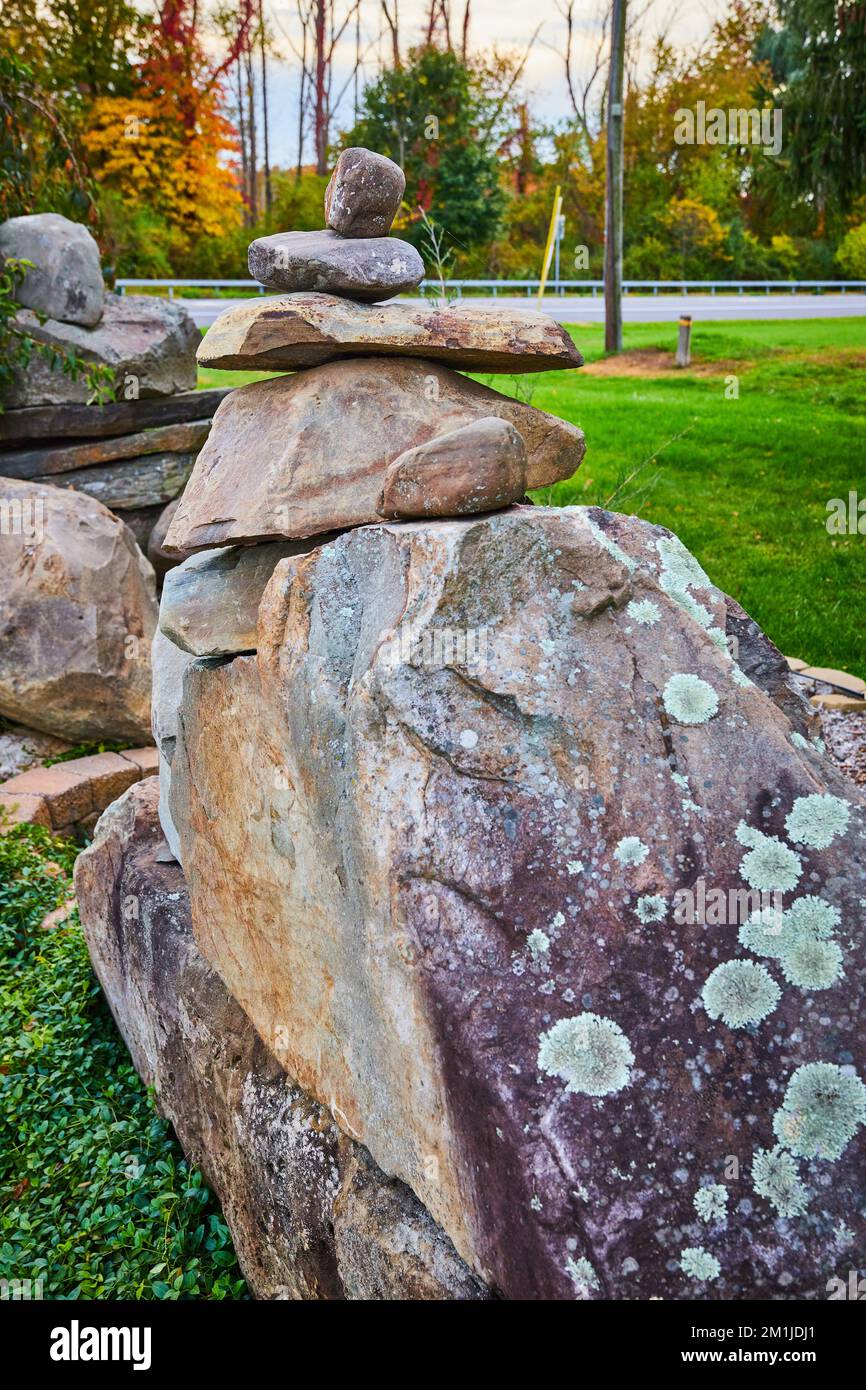 Large cairn stack of rocks with lichen on lawn by road Stock Photo - Alamy
