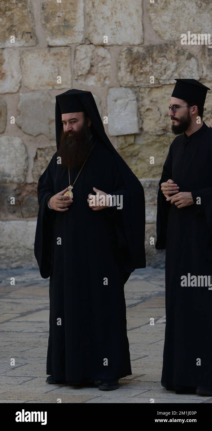 Greek Orthodox priests standing at the courtyard of the Church of the ...
