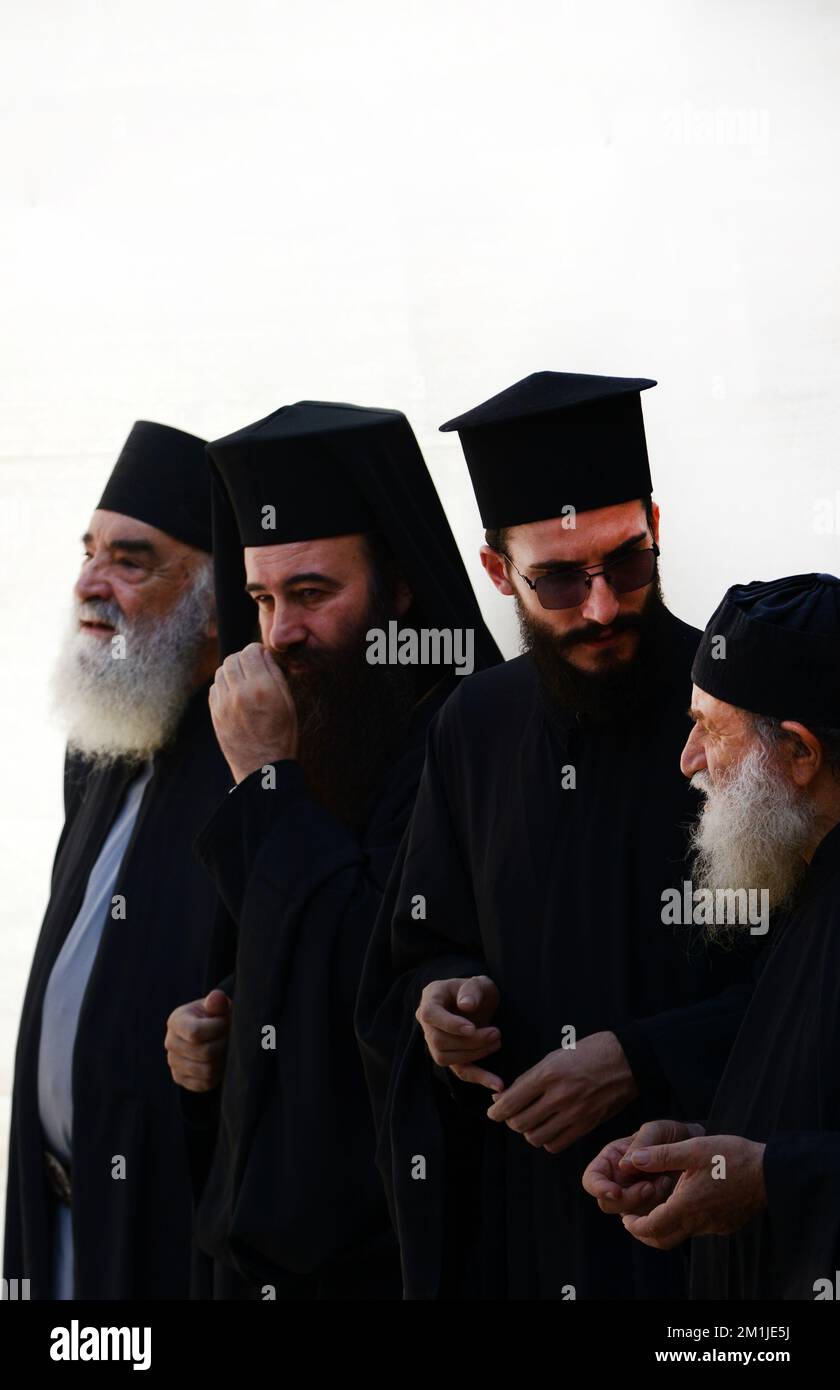 Greek Orthodox priests standing at the courtyard of the Church of the ...