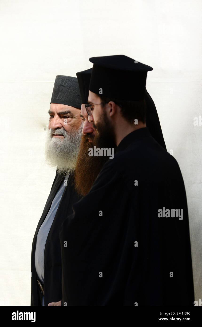 Greek Orthodox priests standing at the courtyard of the Church of the ...