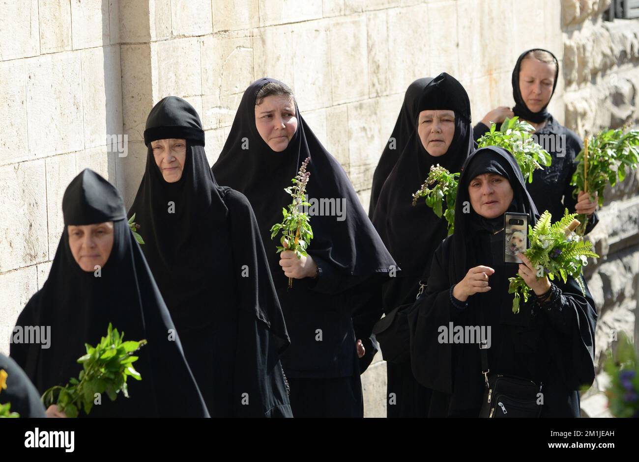 Greek Orthodox nuns walking in a procession from the Tomb off the ...