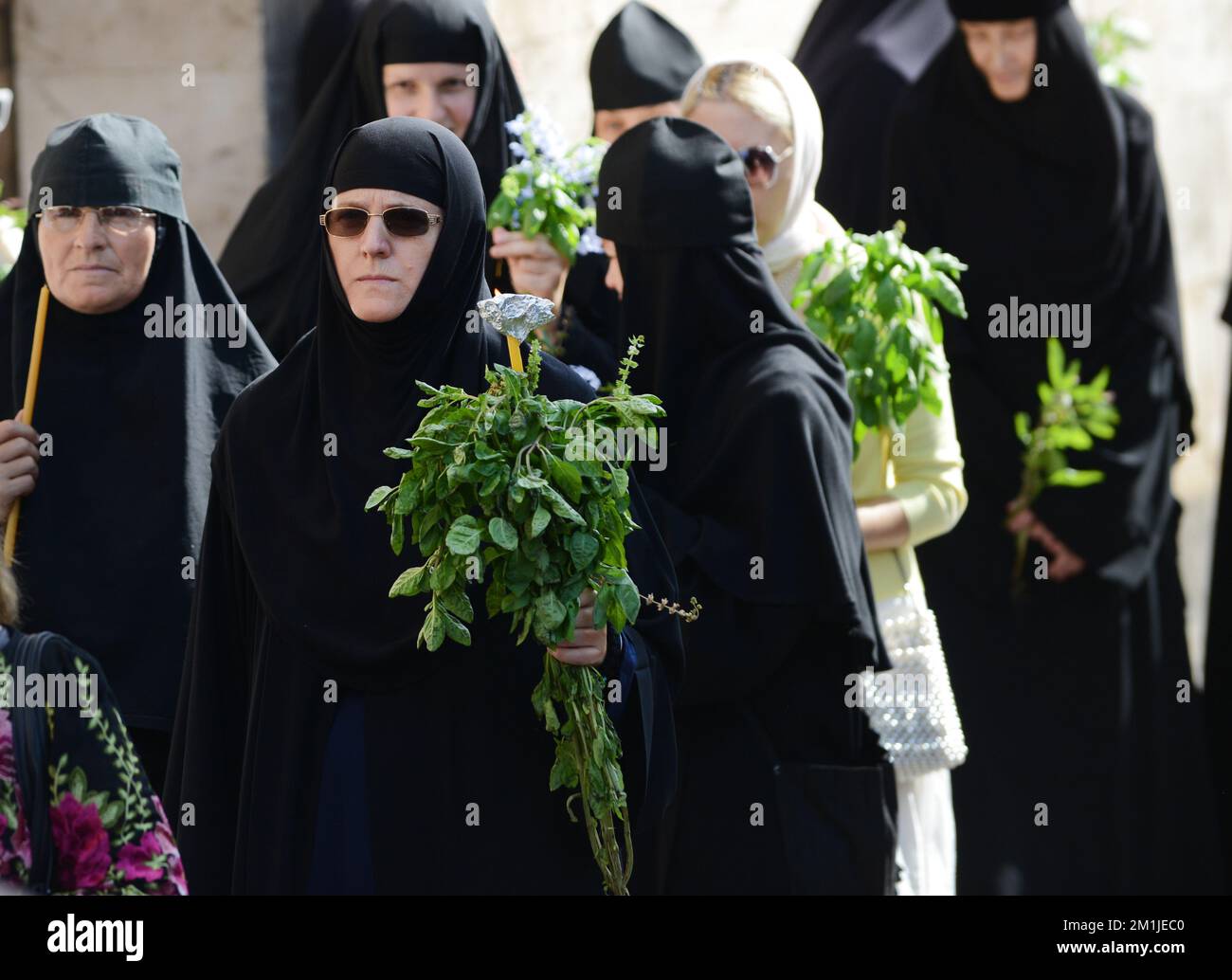 Greek Orthodox nuns walking in a procession from the Tomb off the ...