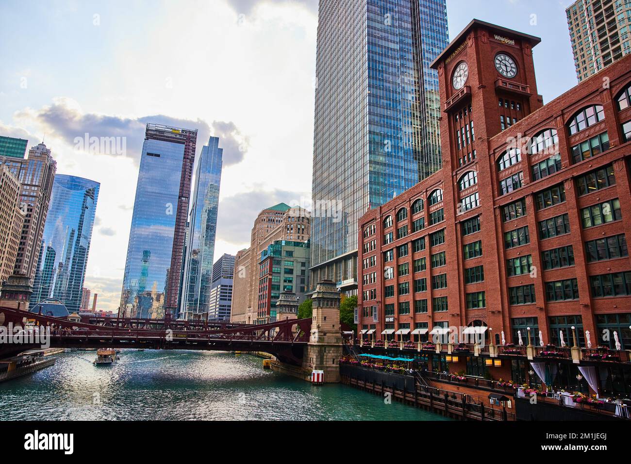 Clock tower next to Chicago ship canal river with bridge and ...