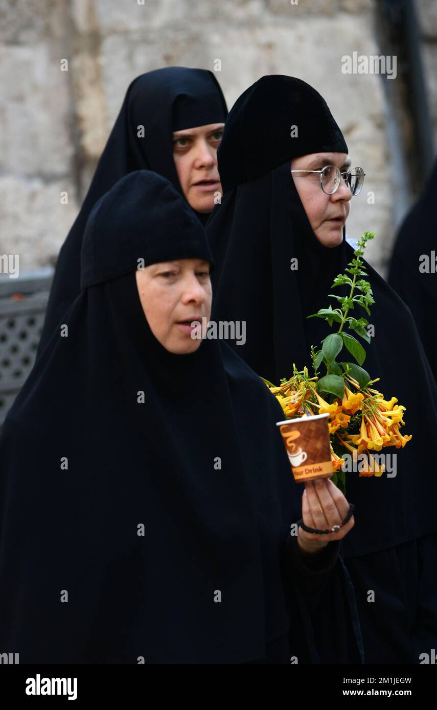 Greek Orthodox nuns walking in a procession from the Tomb off the ...
