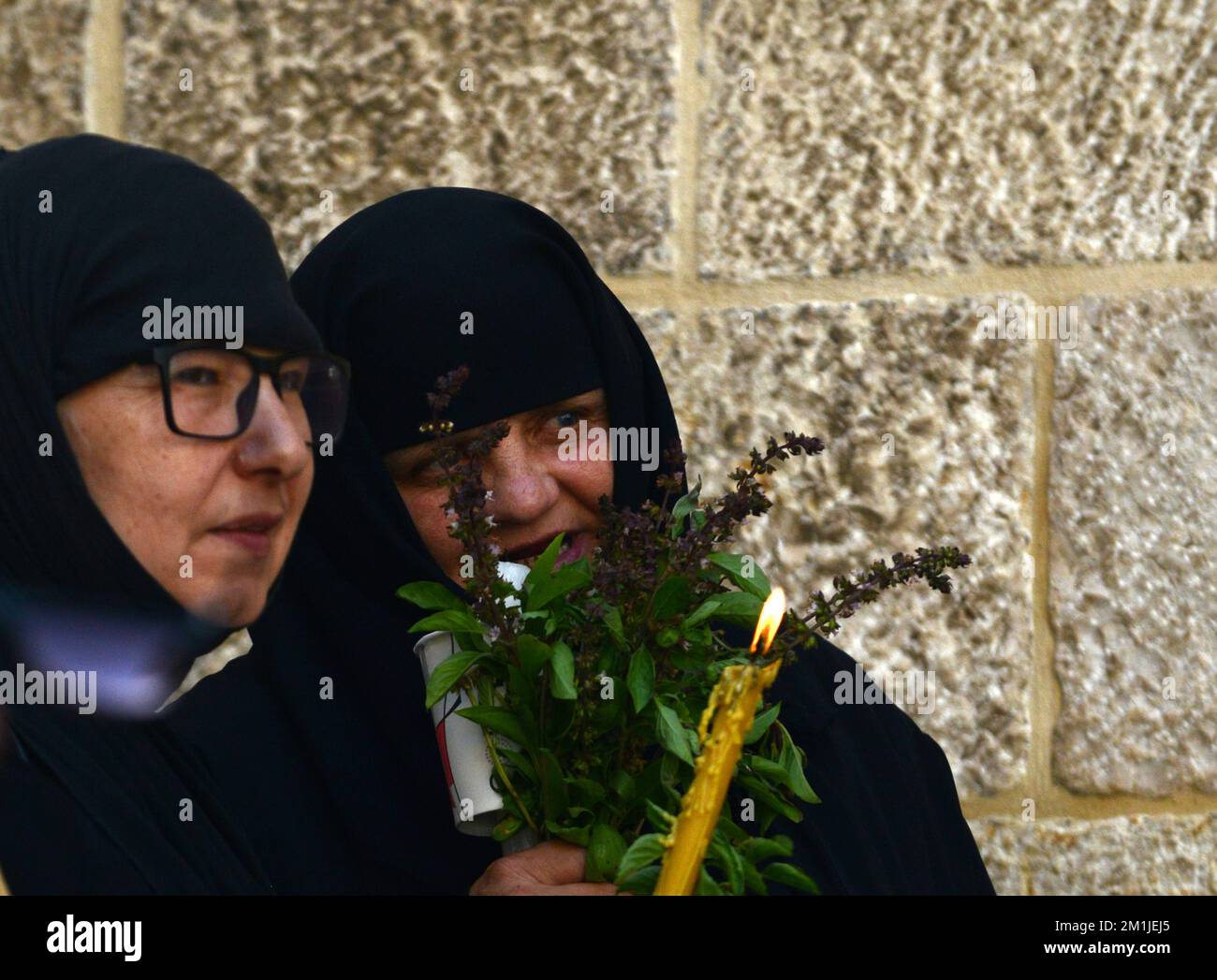 Greek Orthodox nuns walking in a procession from the Tomb off the ...