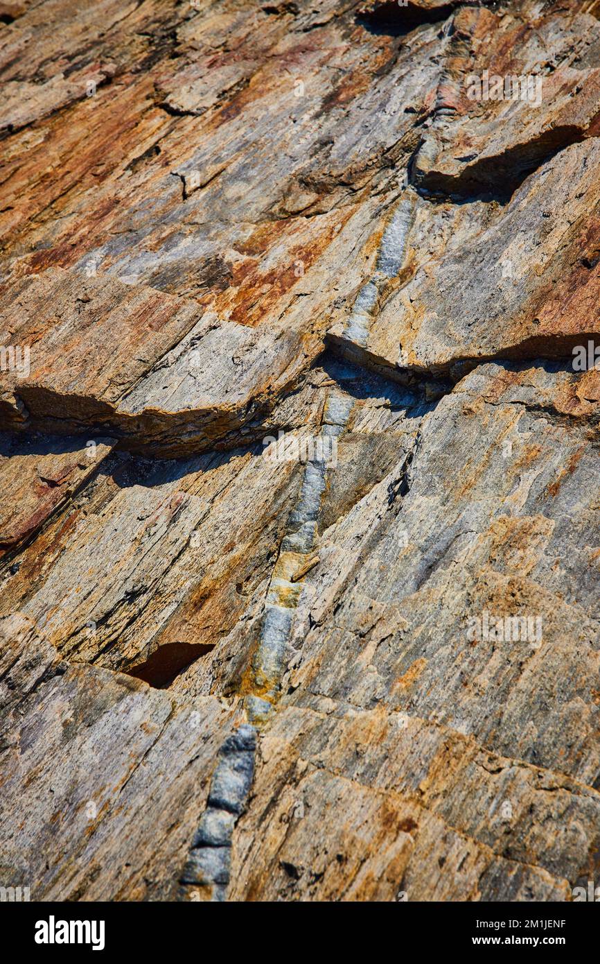 Detail of tiny mineral quartz vein running through rocks in Maine Stock ...