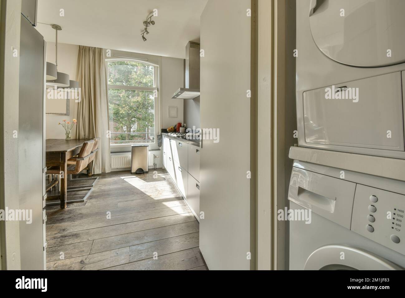 Interior of modern bright laundry room with white walls and dark ...