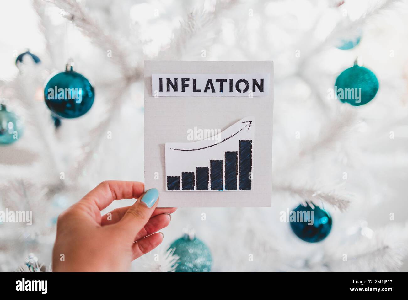 Inflation text and graph with growing stats in front of Christmas tree ...