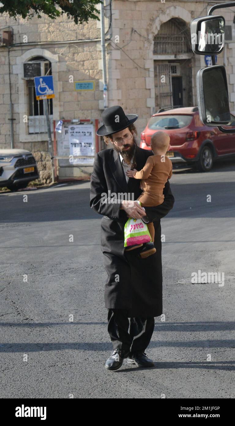 A Haredi man holding his baby daughter in Mea Shearim neighborhood in ...