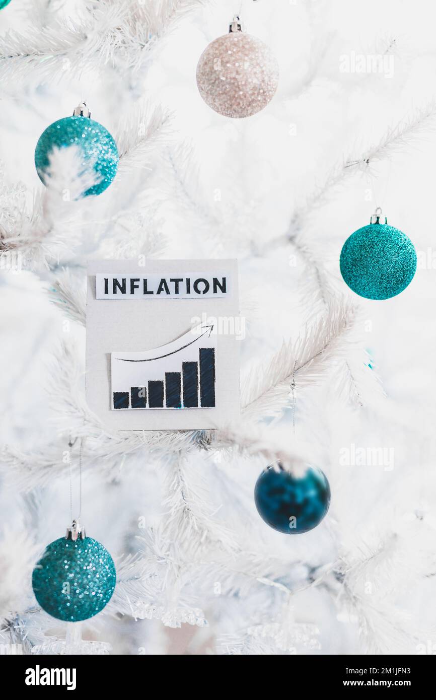 Inflation text and graph with growing stats in front of Christmas tree ...