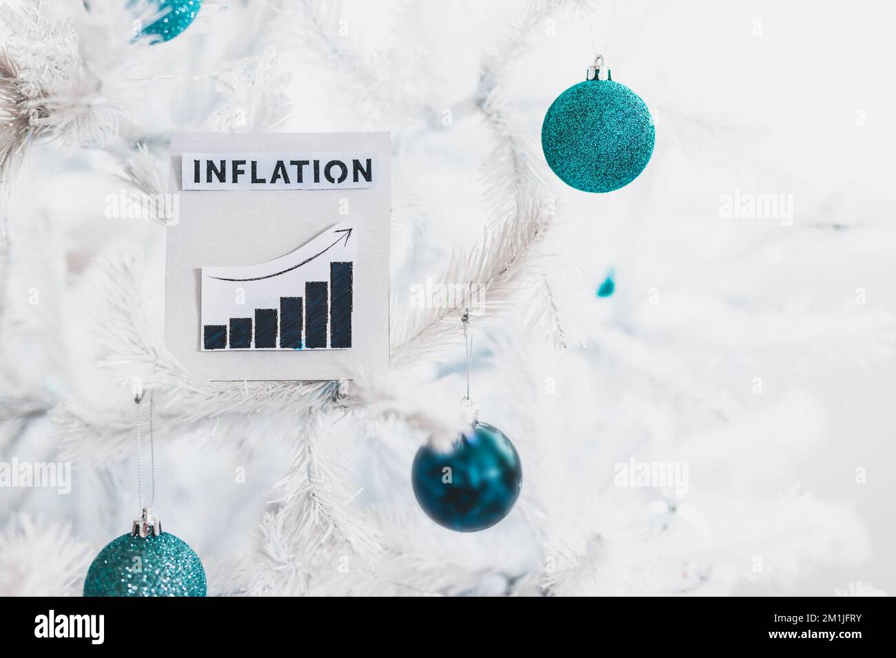 Inflation text and graph with growing stats in front of Christmas tree ...