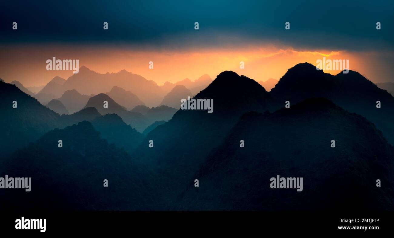 The fanciful scene of the mountains overlapping one another at dawn in ...
