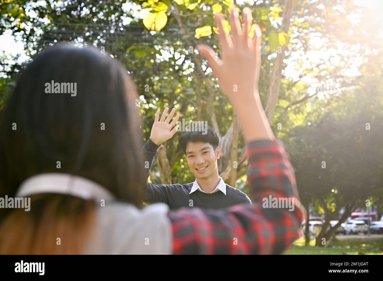 Male to female teenager waving hi-res stock photography and images - Alamy