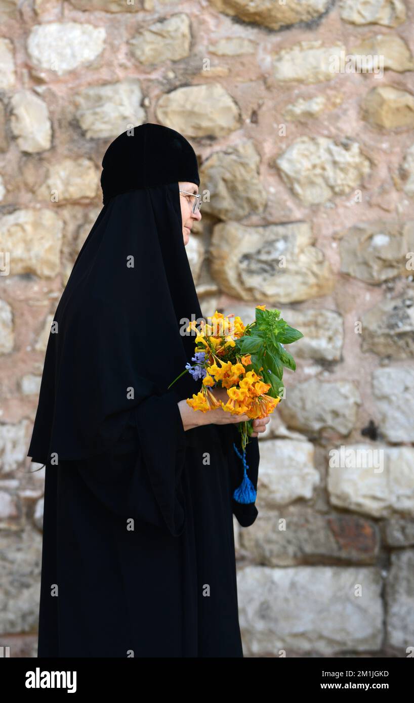 Orthodox Christian nuns gather before the start of a procession from ...