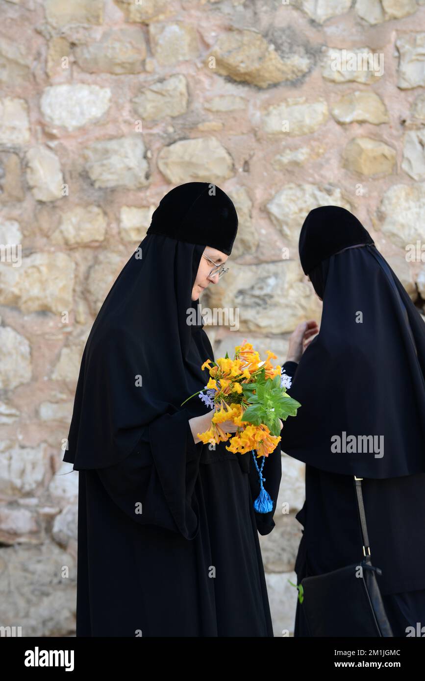 Orthodox Christian nuns gather before the start of a procession from ...