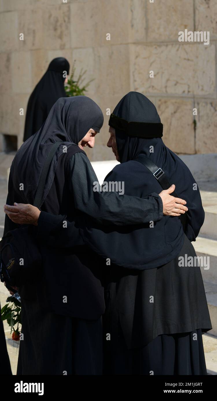 Orthodox Christian nuns gather before the start of a procession from ...